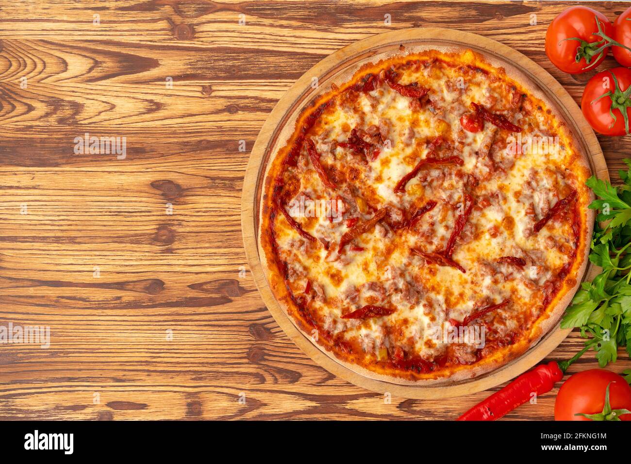 Top view of freshly baked pizza on wooden background Stock Photo - Alamy