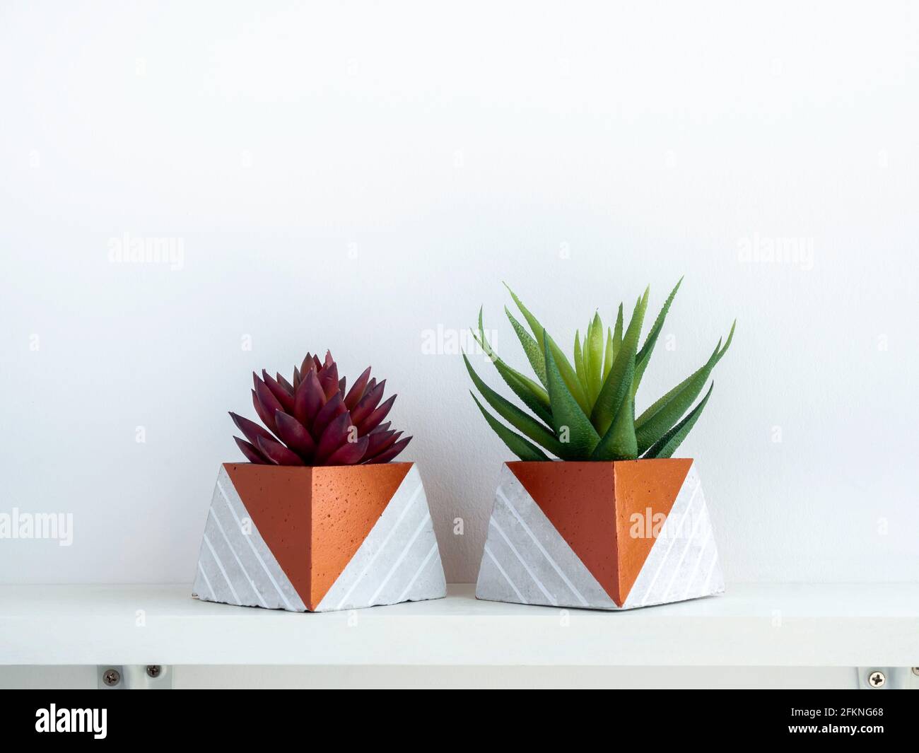 DIY concrete pots, pyramid shape with green and red succulent plants on ...