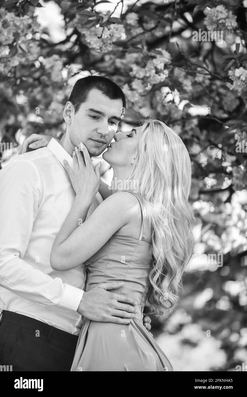 Loving people hug. Couple in love under sakura blossom. Love story ...