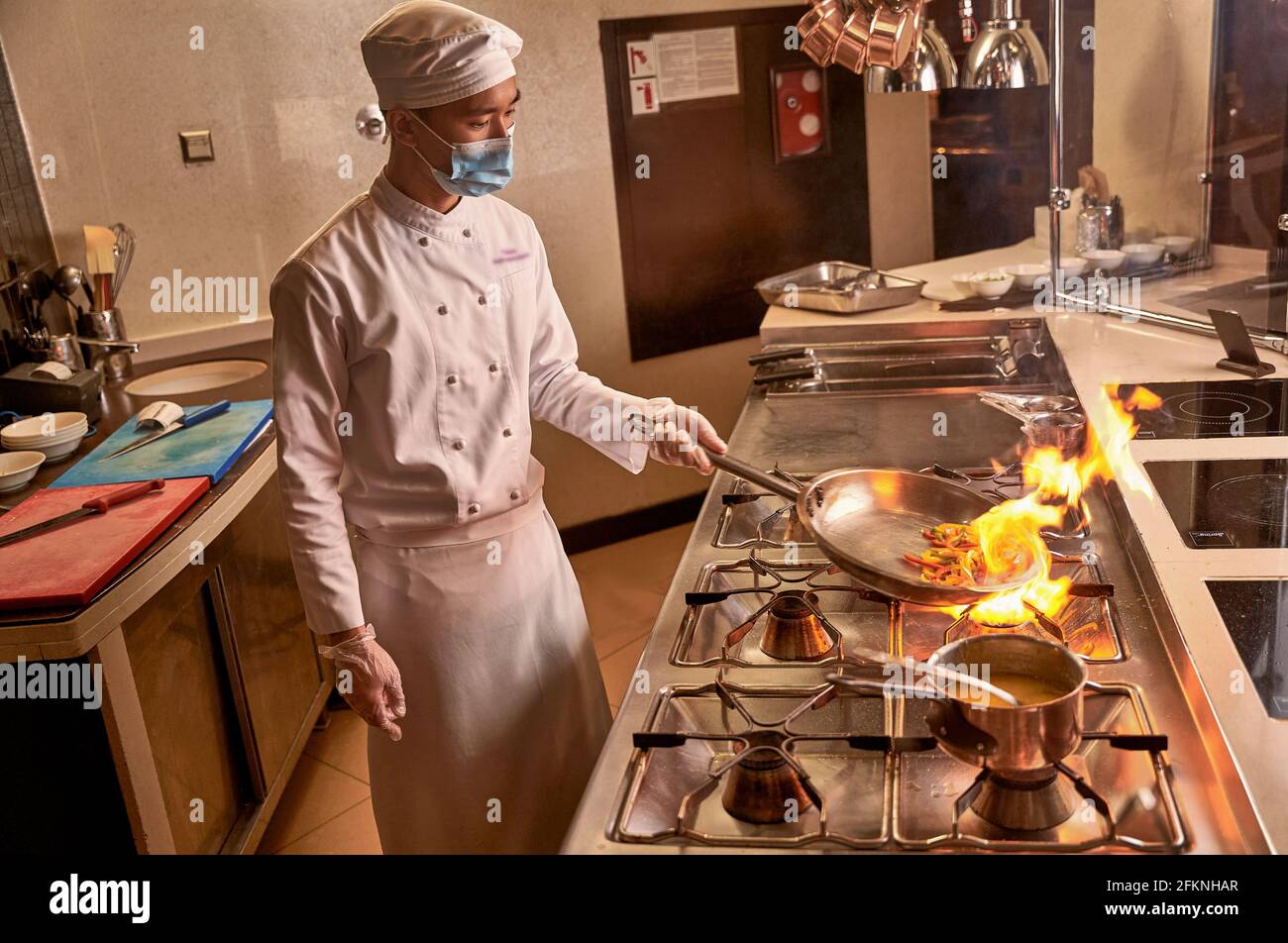 Burning vegetables on fire lying in frying pan Stock Photo - Alamy