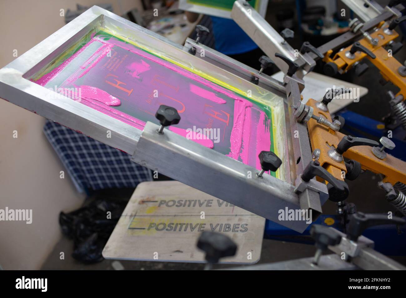 Serigraphy silk screen print process at clothes factory. Frame ...