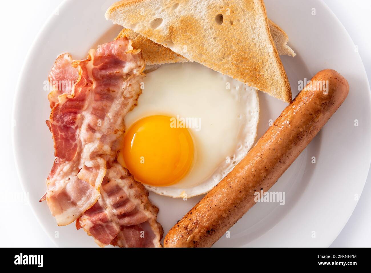 Traditional American breakfast with fried egg,toast,bacon and sausage ...