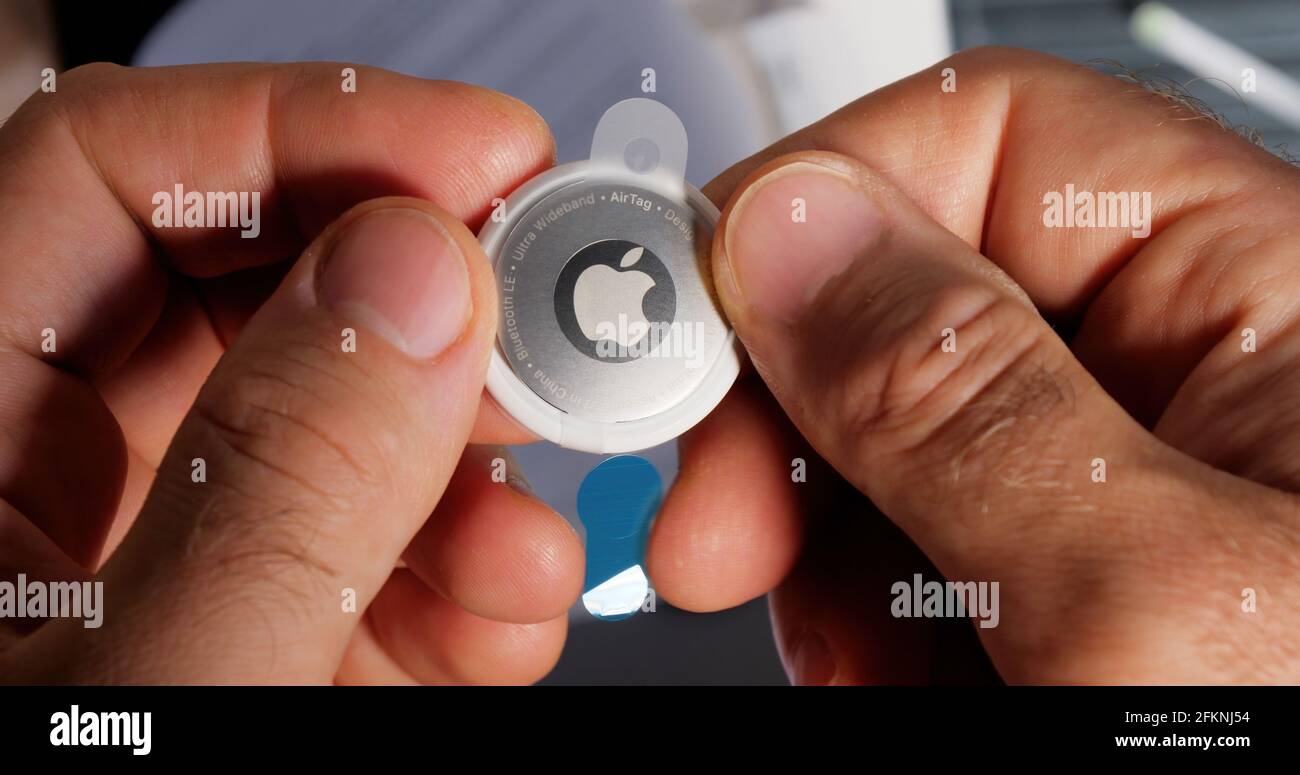 an pov unboxing removing plastic film from AirTag Stock Photo - Alamy