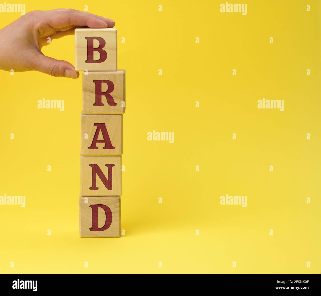 wooden blocks with the inscription brand on ayellow background. Brand ...