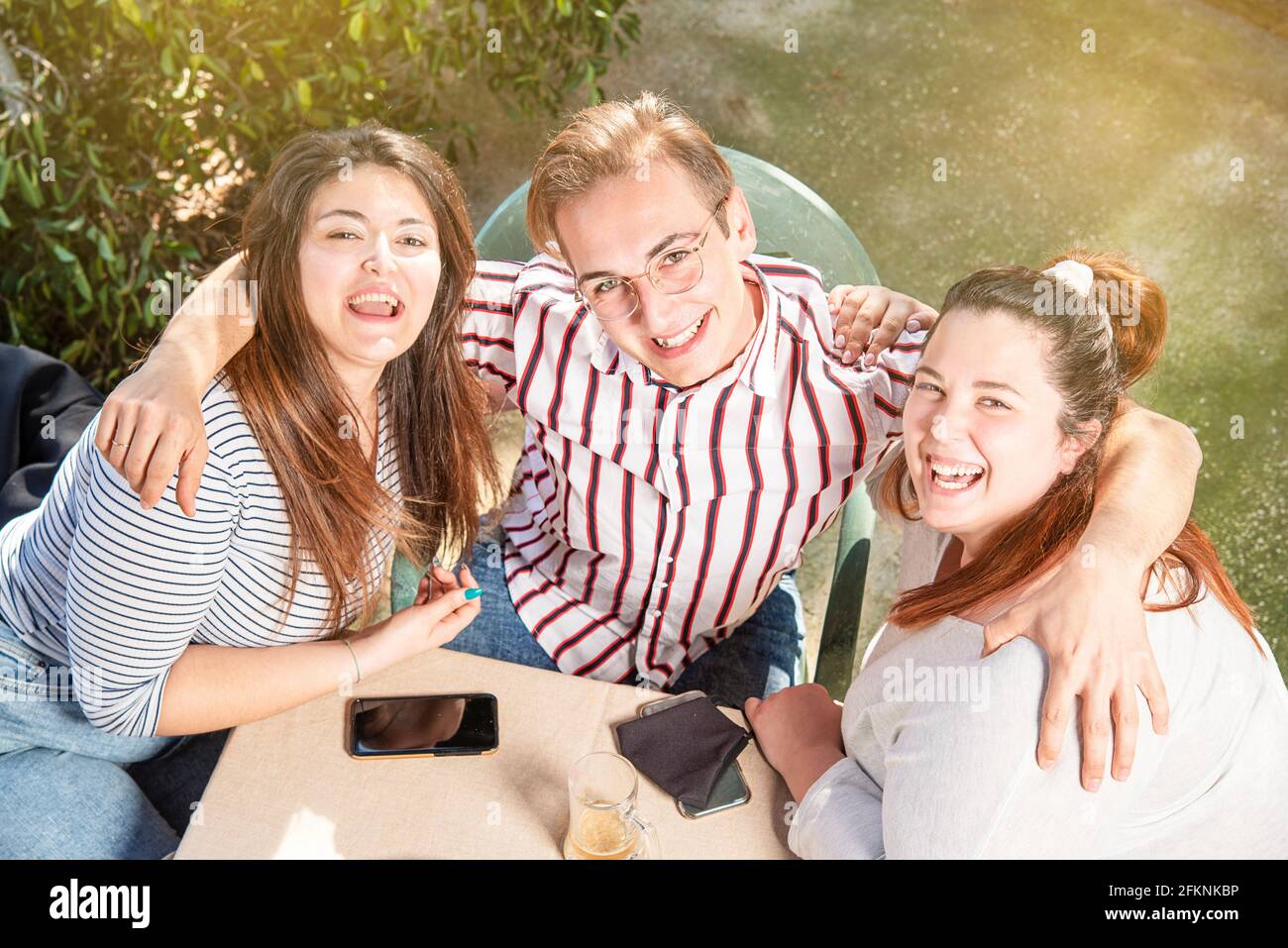 three friends smile outdoors ready to celebrate Stock Photo - Alamy