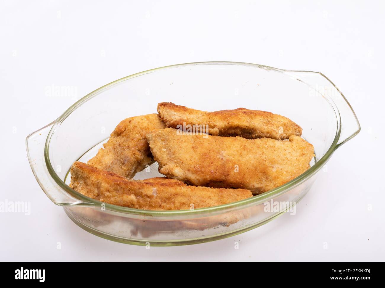 Breaded fish fillets in a glass, heat-resistant dish Stock Photo - Alamy