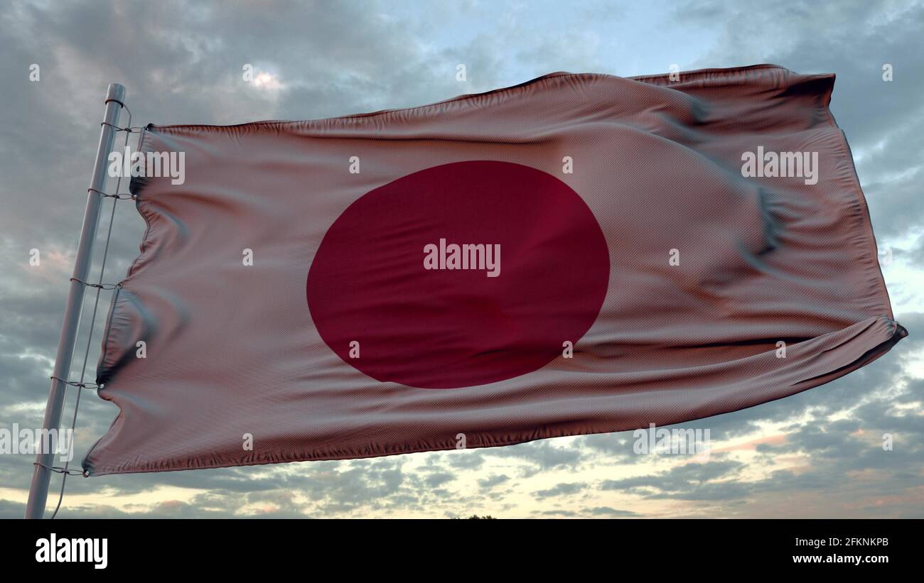 Flag of Japan waving in the wind against deep beautiful sky at sunset ...
