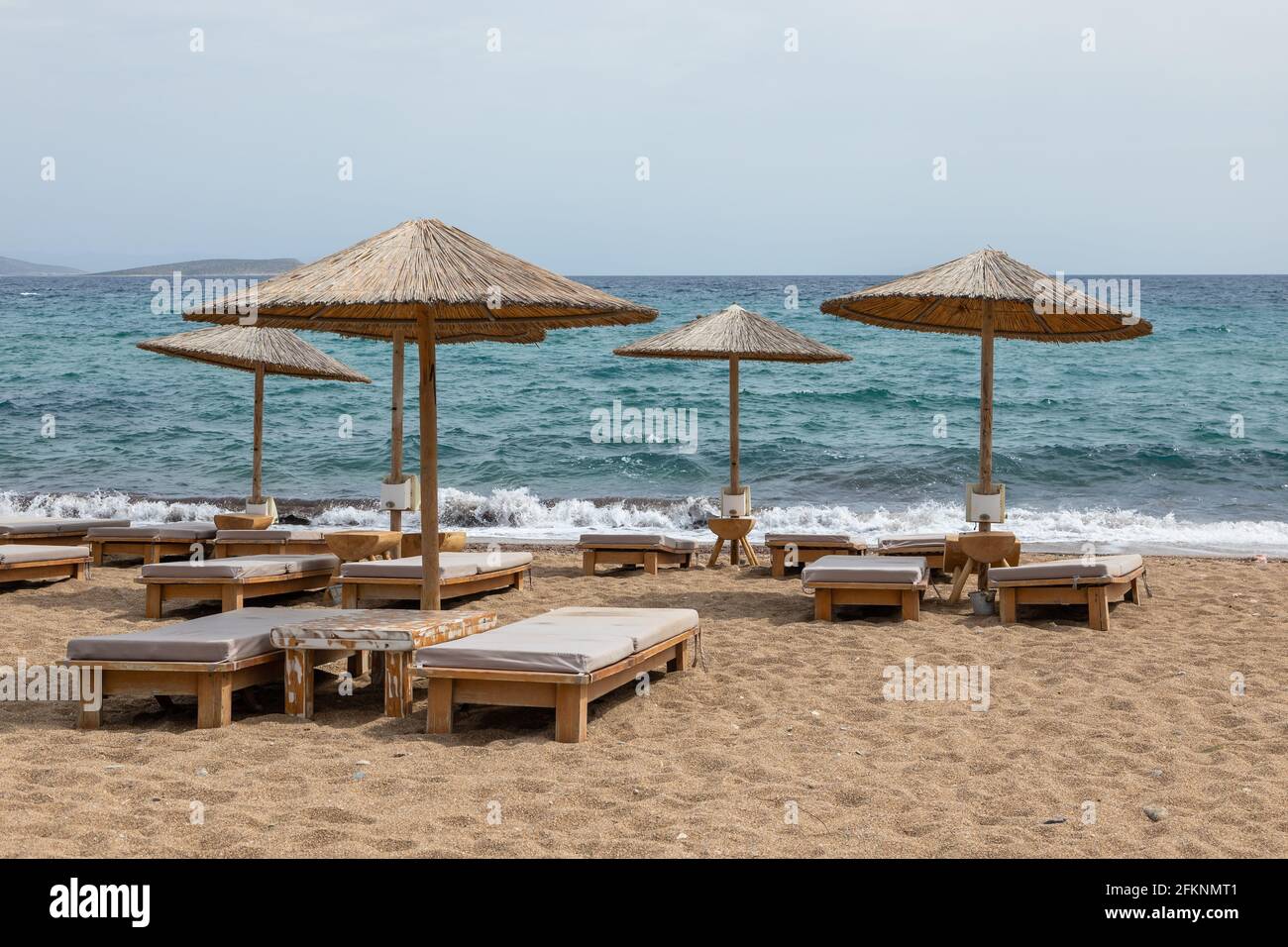 View of sandy Soros Beach on the Greek island of Antiparos with sunbeds ...