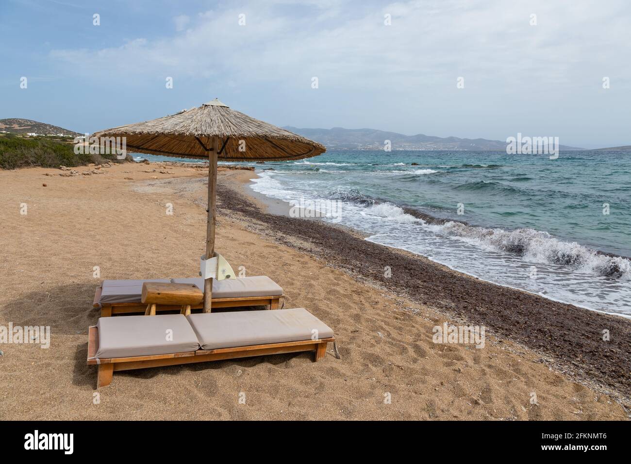 View of sandy Soros Beach on the Greek island of Antiparos with sunbeds ...