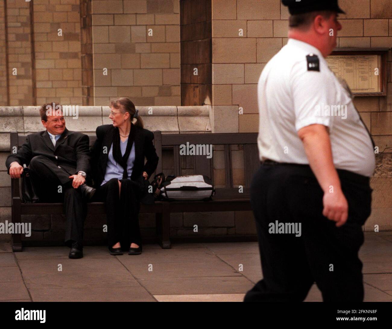 Pierre Yves Gerbeau waits with a collegue June 2000on a bench outside ...