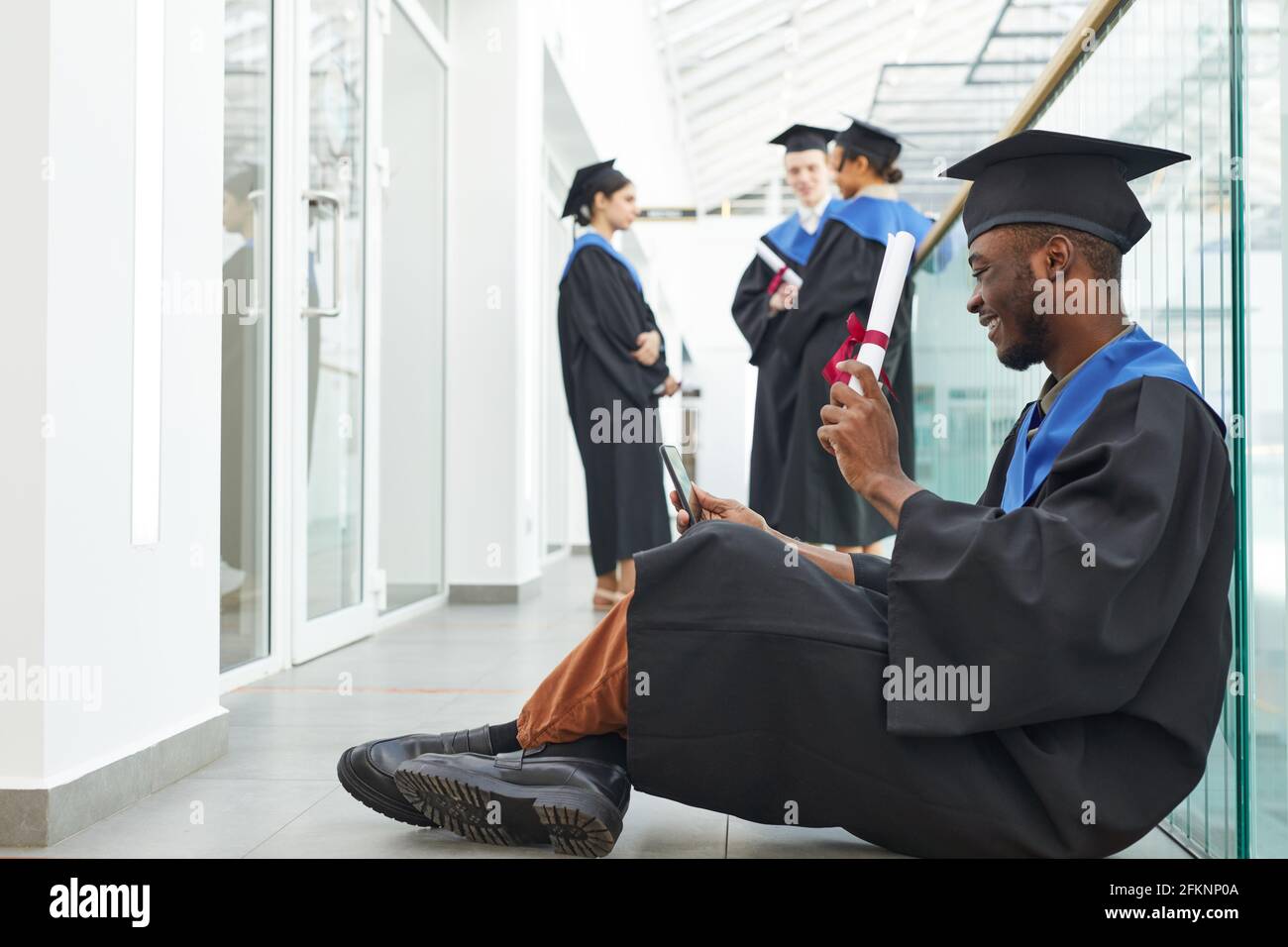 Happy graduate student diploma sitting hi-res stock photography and ...