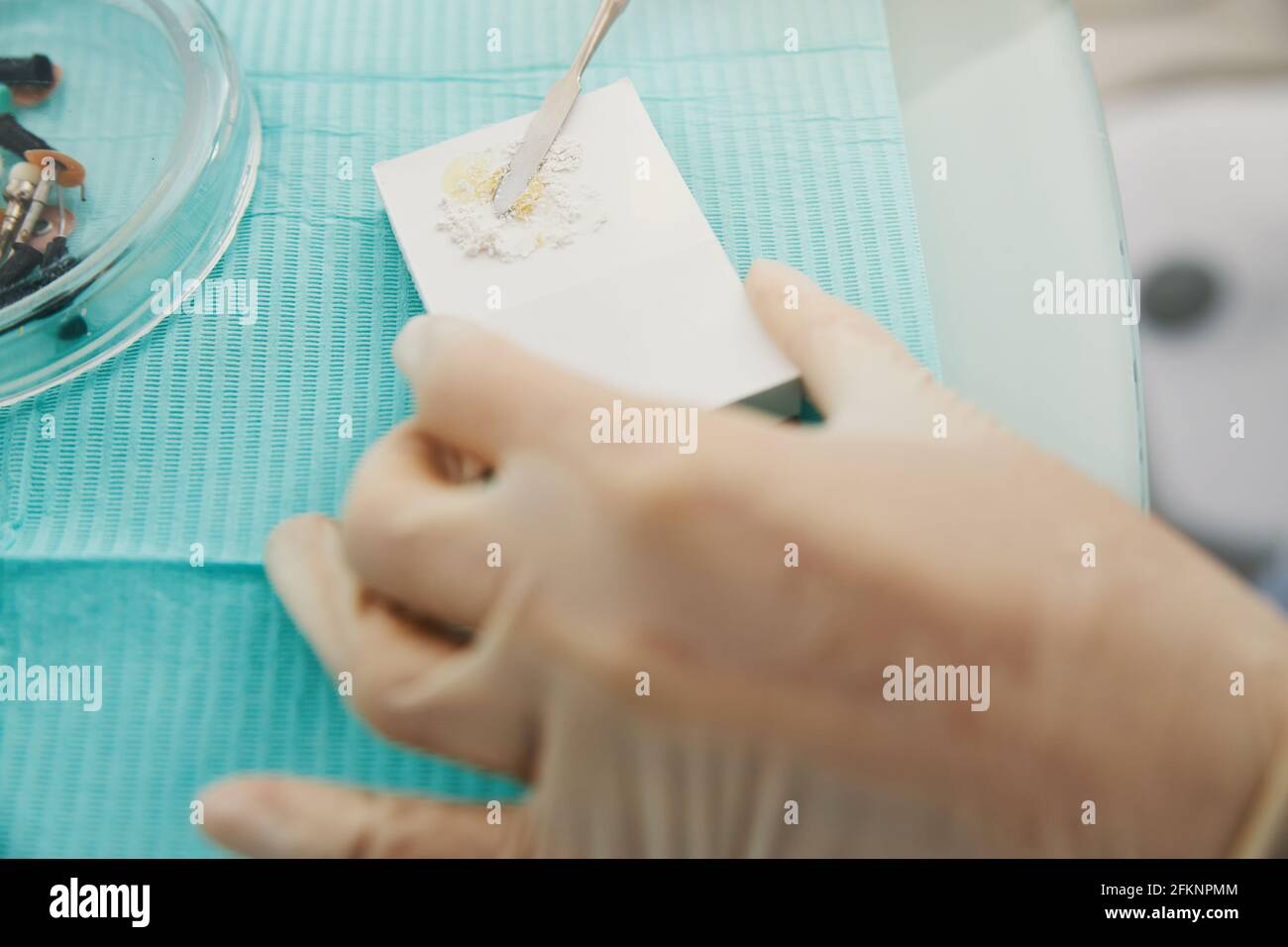 Doctor mixing zinc oxide powder and oil with steel spatula Stock Photo ...