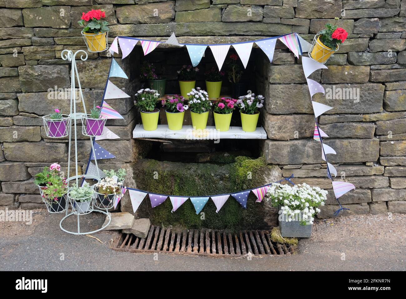 A well dressing within a dry stone wall on Spaw Sunday in the ...