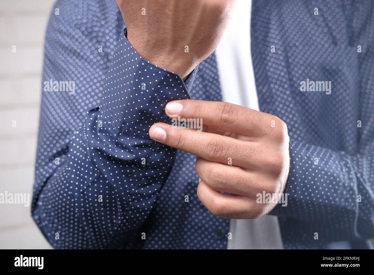Buttoning his shirt hi-res stock photography and images - Alamy