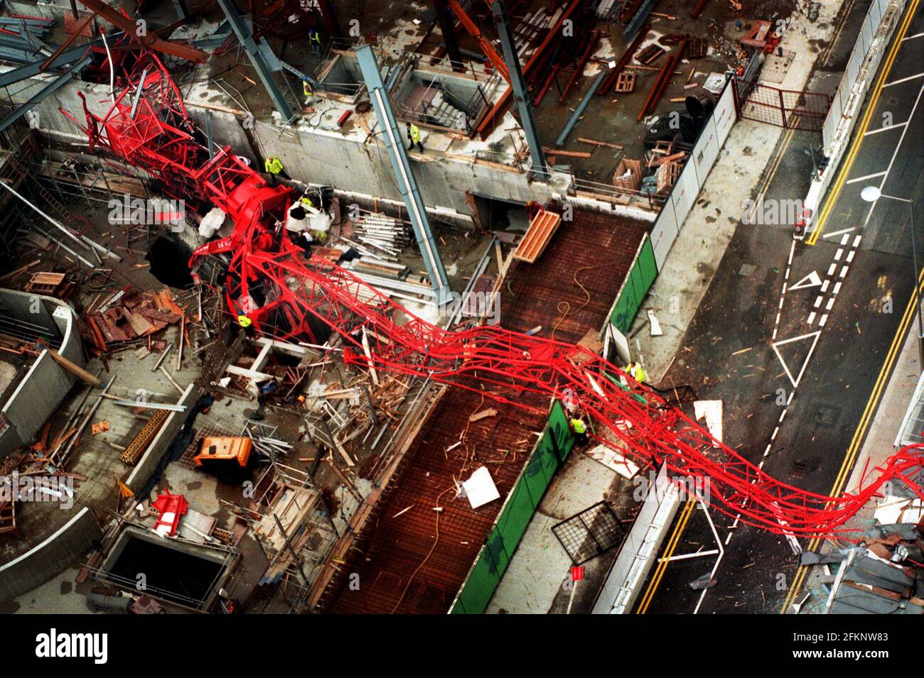 The arm of the crane lies collapsed where it fell to the ground May 21 ...