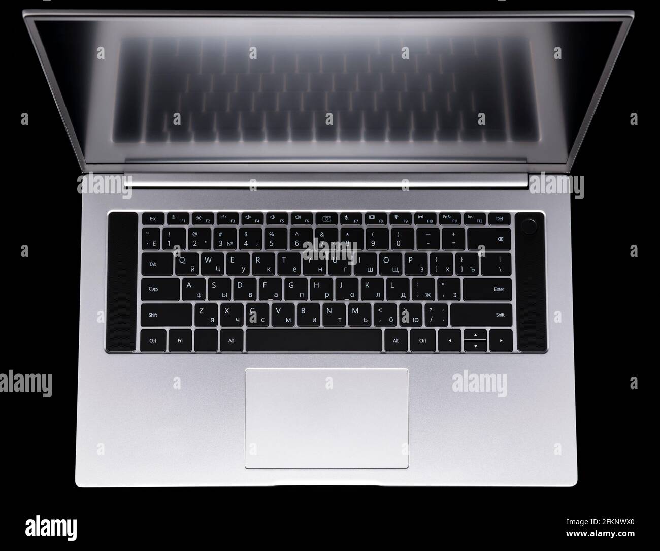 Silver Laptop and keyboard against a black background. Laptop keyboard ...