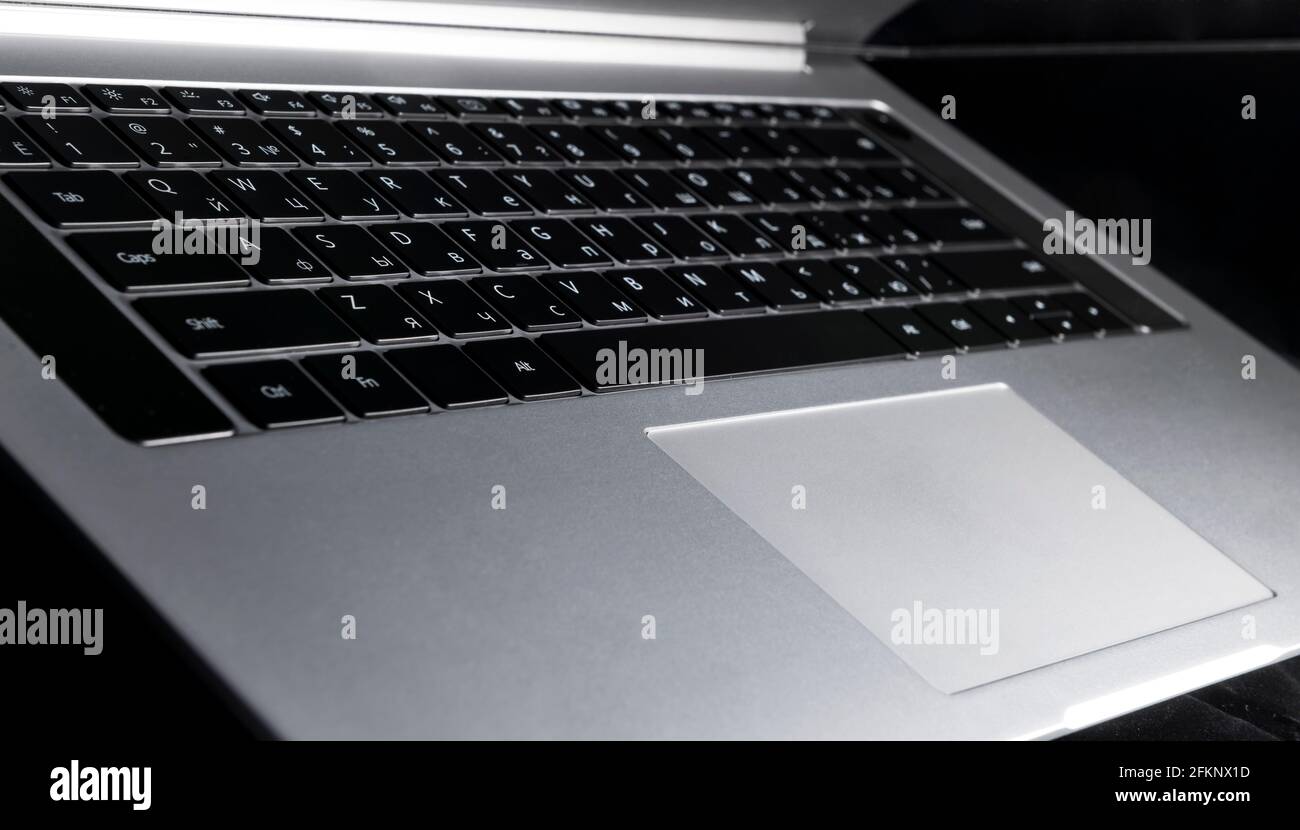 Silver Laptop and keyboard against a black background. Laptop keyboard ...