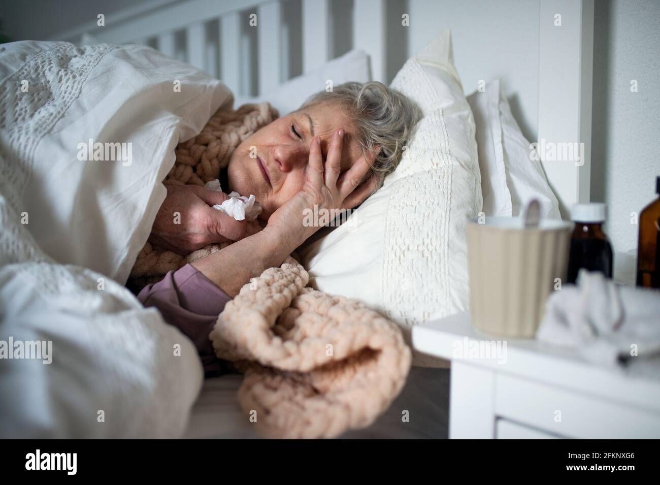 Sick senior woman sleeping in bed at home, cold and flu concept Stock ...