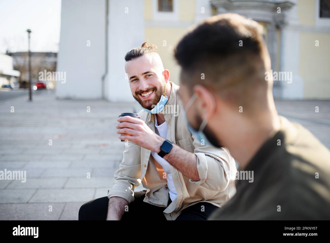 Men friends outdoors on street in town talking, coronavirus and new ...