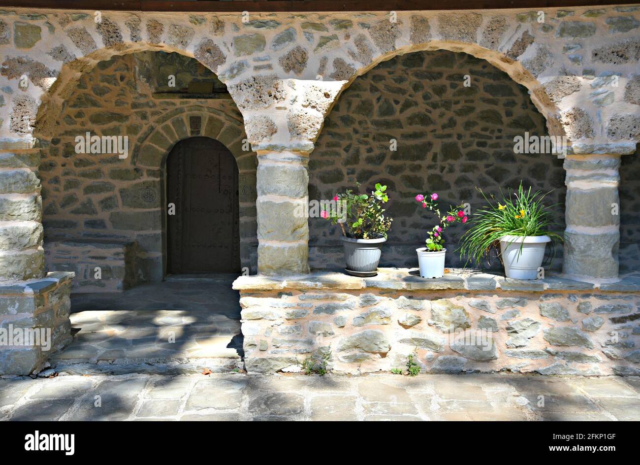 Traditional Greek Orthodox church stone arched facade in Tristeno, a ...