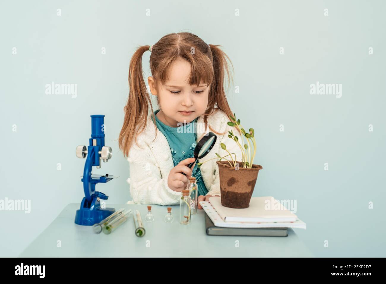 education concept. Little baby Girl look at microscopes in the ...