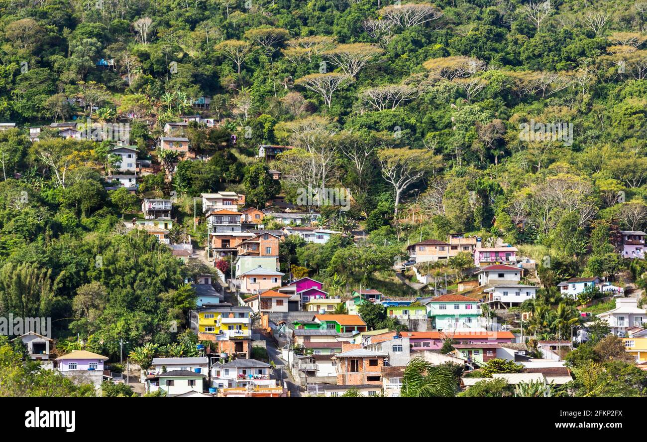 Shot of a hill with houses and forest Stock Photo - Alamy