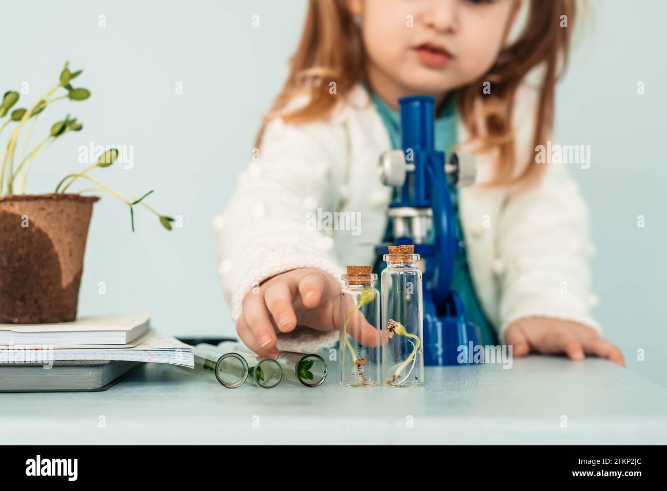education concept. Little baby Girl look at microscopes in the ...