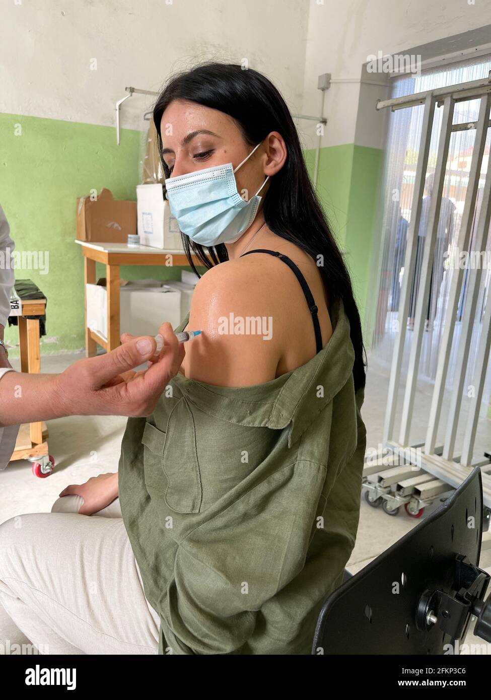 Woman receiving an injection in her arm Stock Photo - Alamy