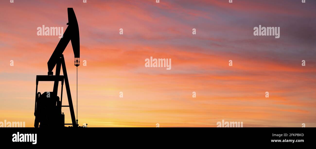 Silhouette of oil rig at sunset Stock Photo - Alamy