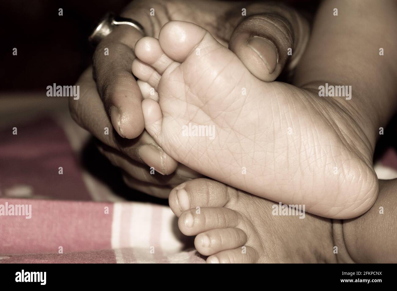 Newborn Baby Feet in Mother Hands. Beautiful infant little baby fingers ...