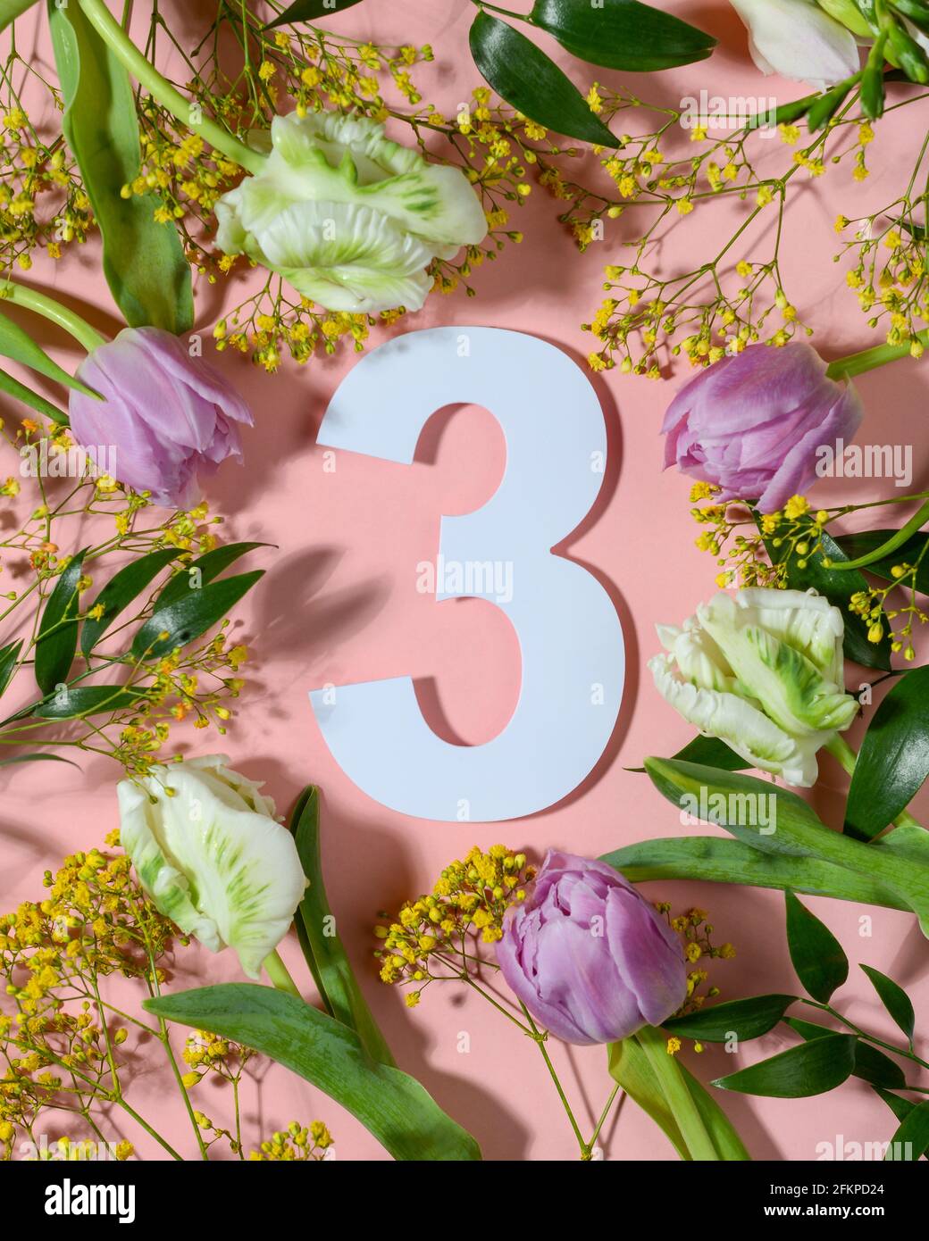 Number three on pink background with colorful flowers. Flat lay, top ...