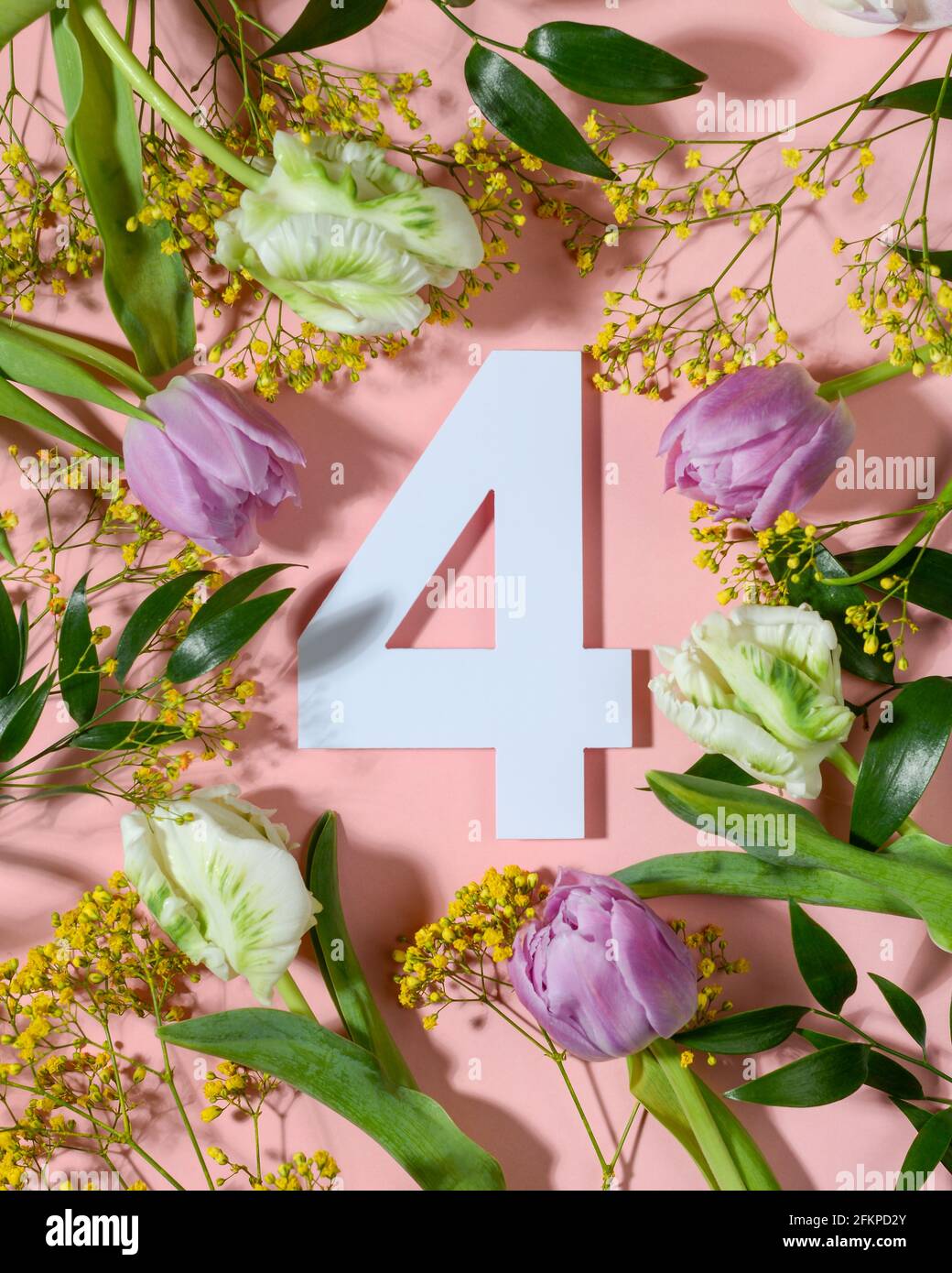 Number four on pink background with colorful flowers. Flat lay, top ...