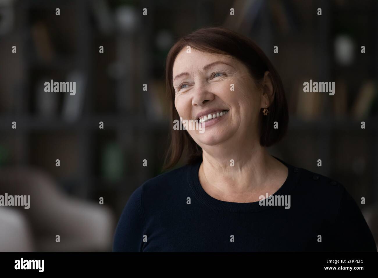 Happy mature woman look in distance dreaming Stock Photo - Alamy