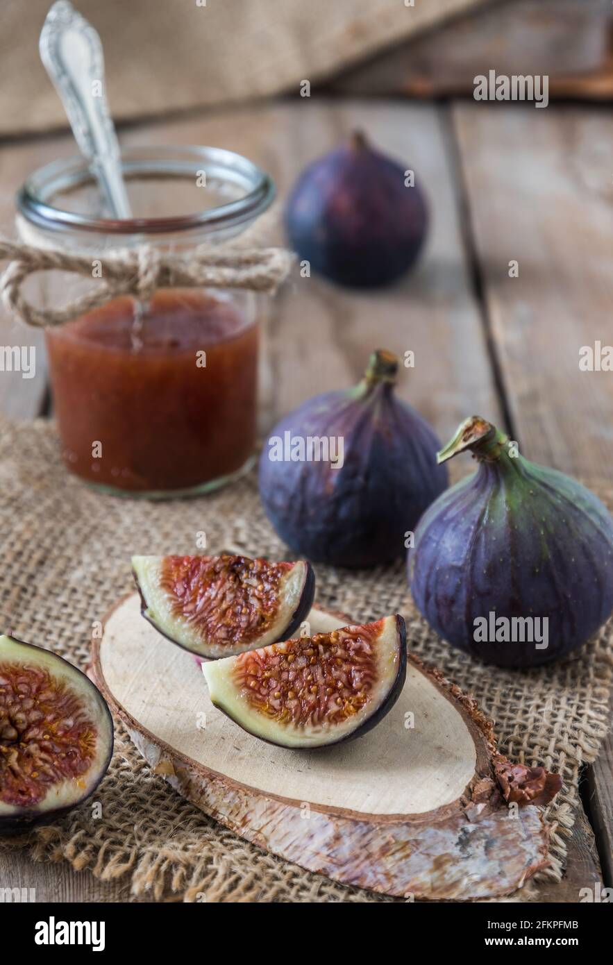Fig jam in a jar on a rustic wooden table, vertical stock photo Stock ...