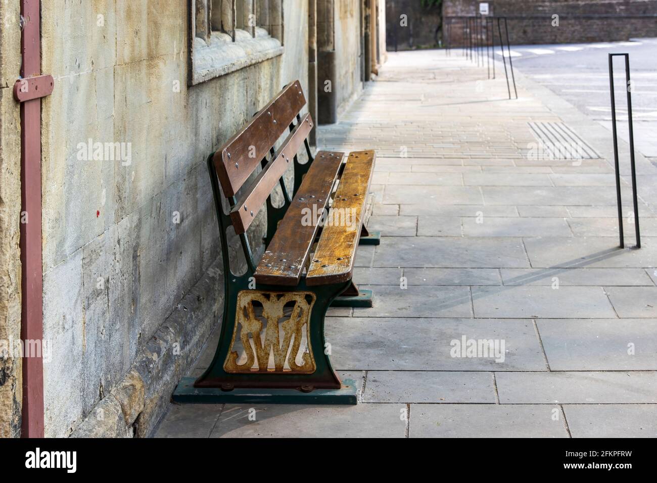 view of a bench at Bath Spa railway station. In the metal frame are the ...