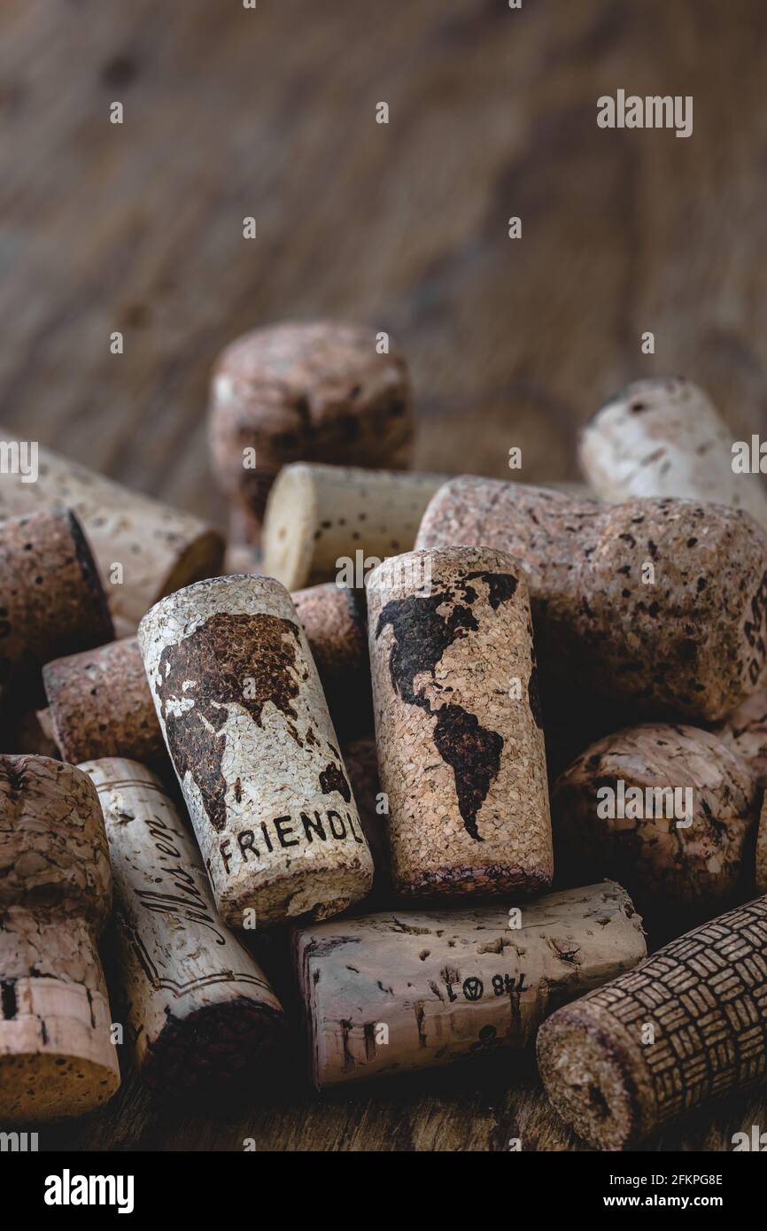 Two corks on a pile of used corks which show a world map and the word ...