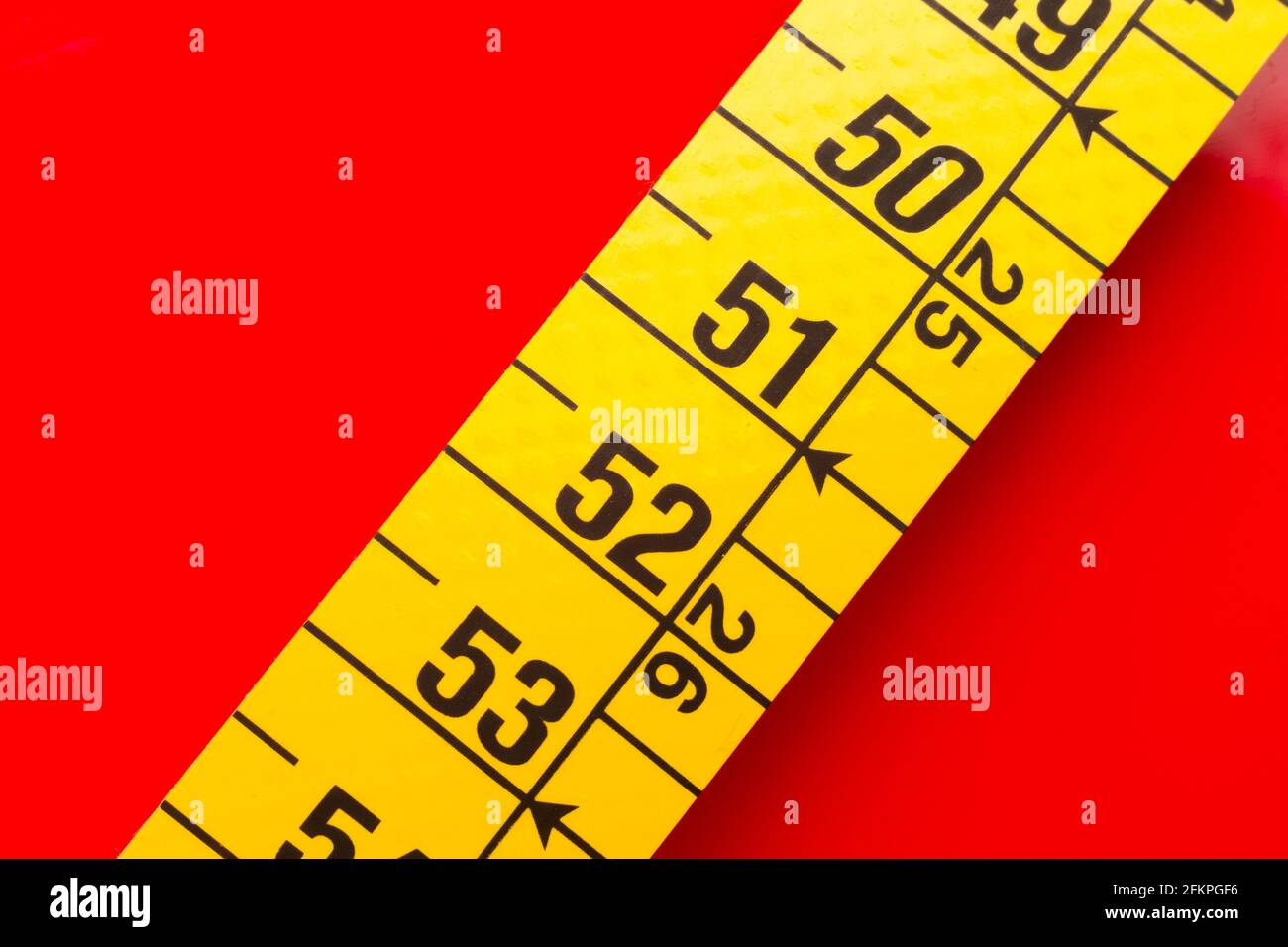 Yellow tape measure for measuring perimeters of objects; tailor's and ...