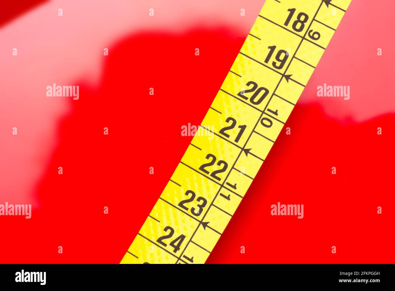 Yellow tape measure for measuring perimeters of objects; tailor's and ...