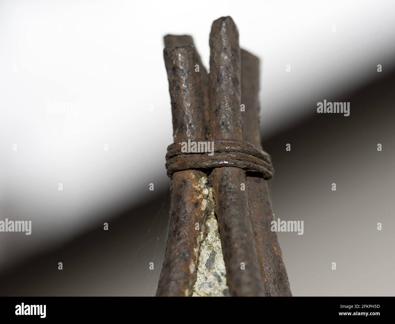 rusted iron bars crossed and tied up with metal rope Stock Photo - Alamy
