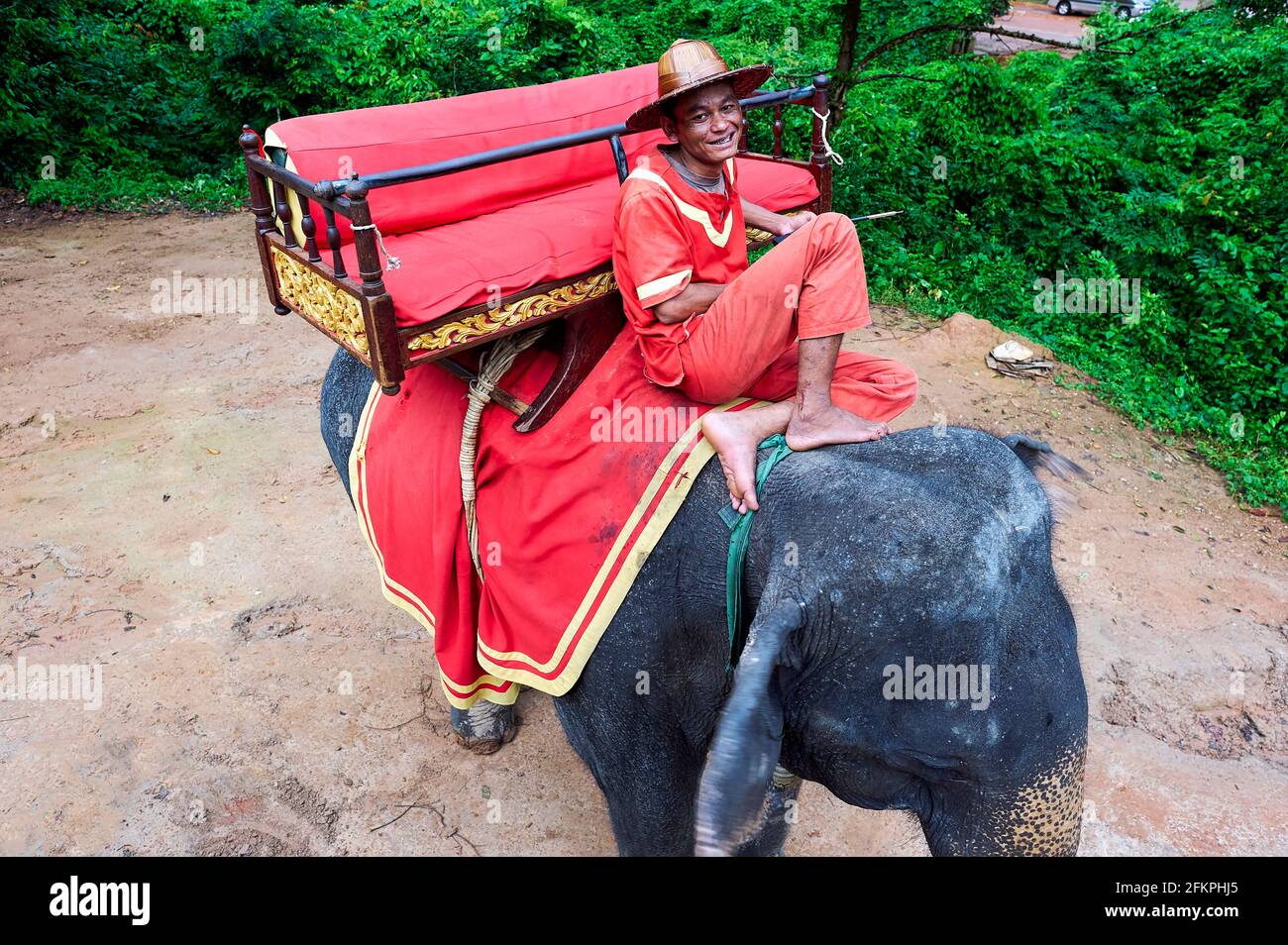 An elephant driver waiting for tourists at Angkor Wat Temple. Cambodia ...