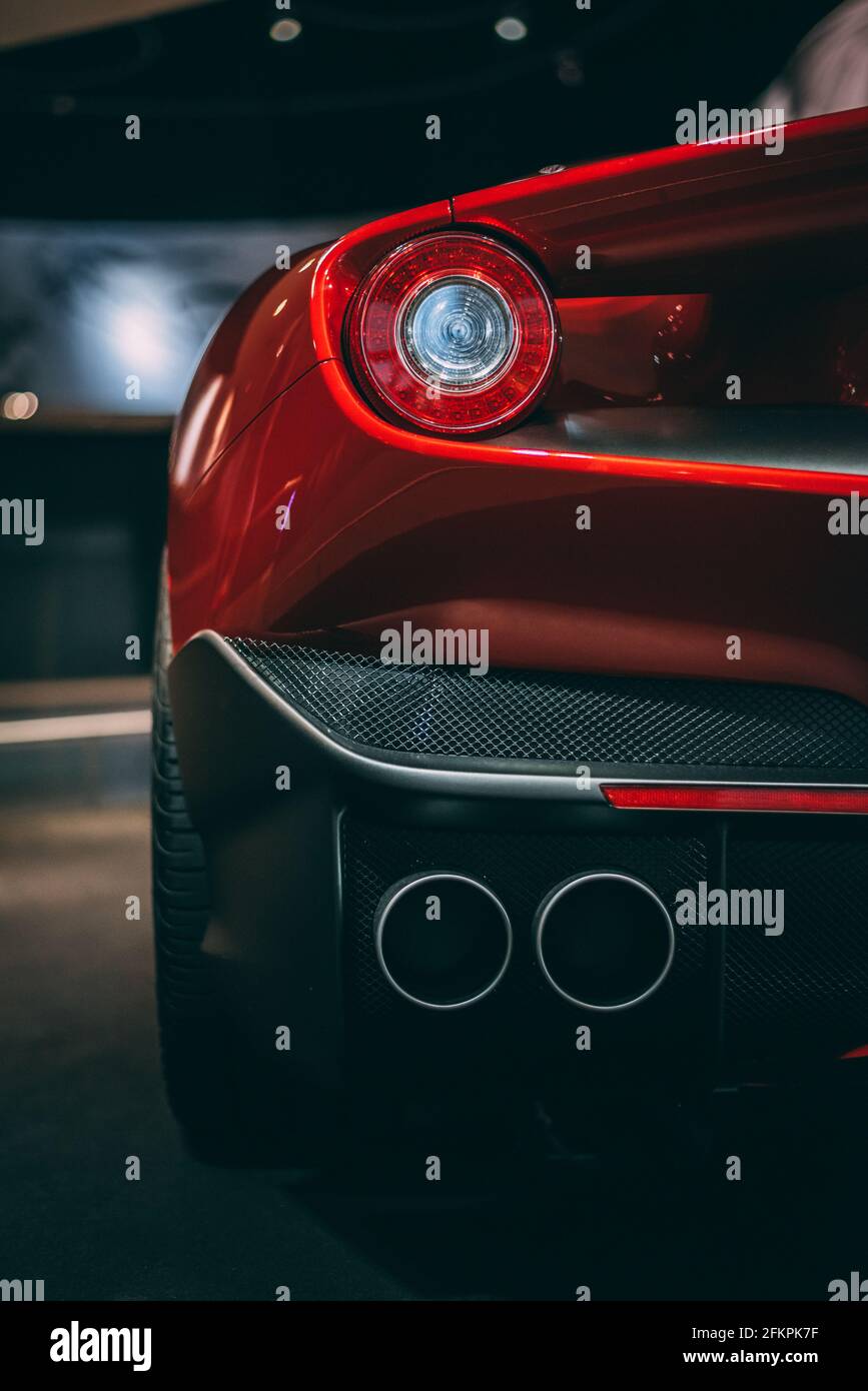 Rear lights and exhaust pipes of a red sport car Stock Photo - Alamy