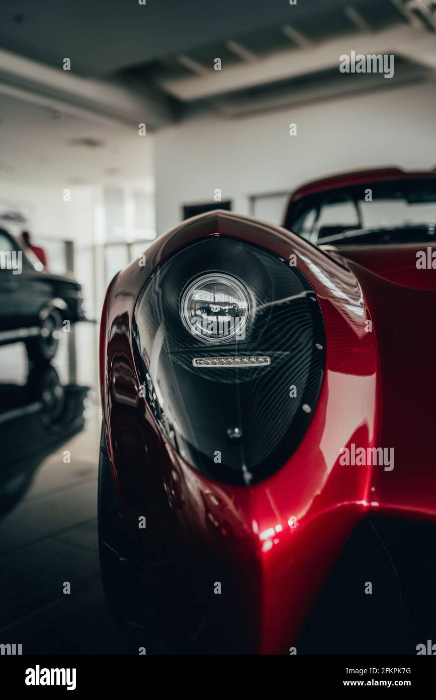 Headlights of a red sport car Stock Photo - Alamy