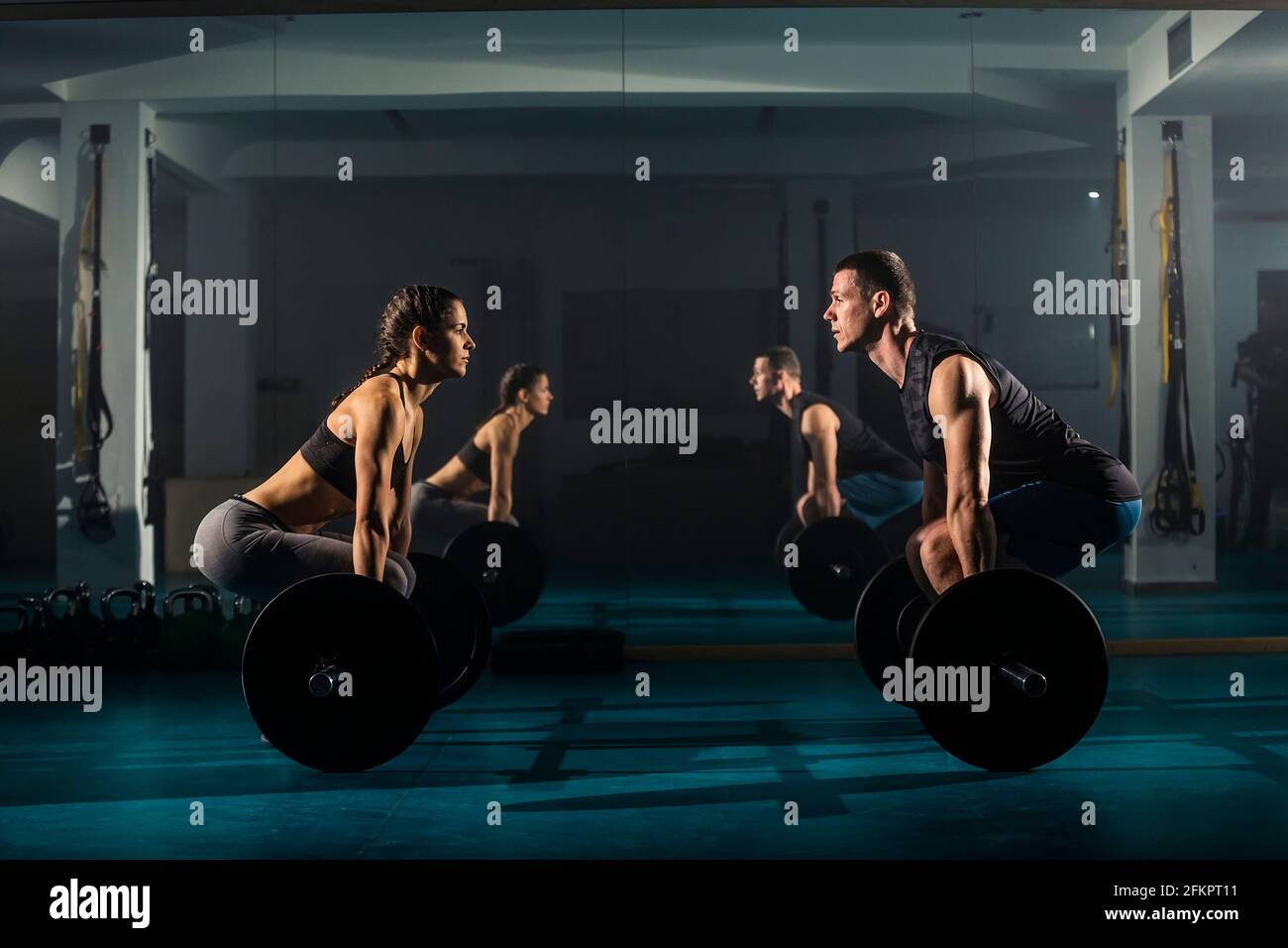 A female and a male training together and simultaneously doing dead ...