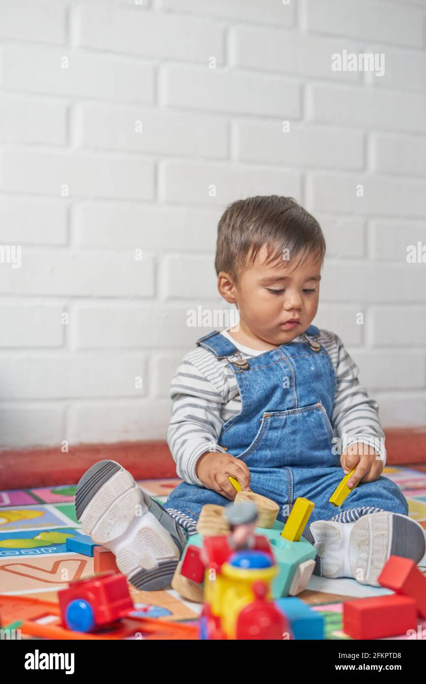 Baby playing in house Stock Photo - Alamy