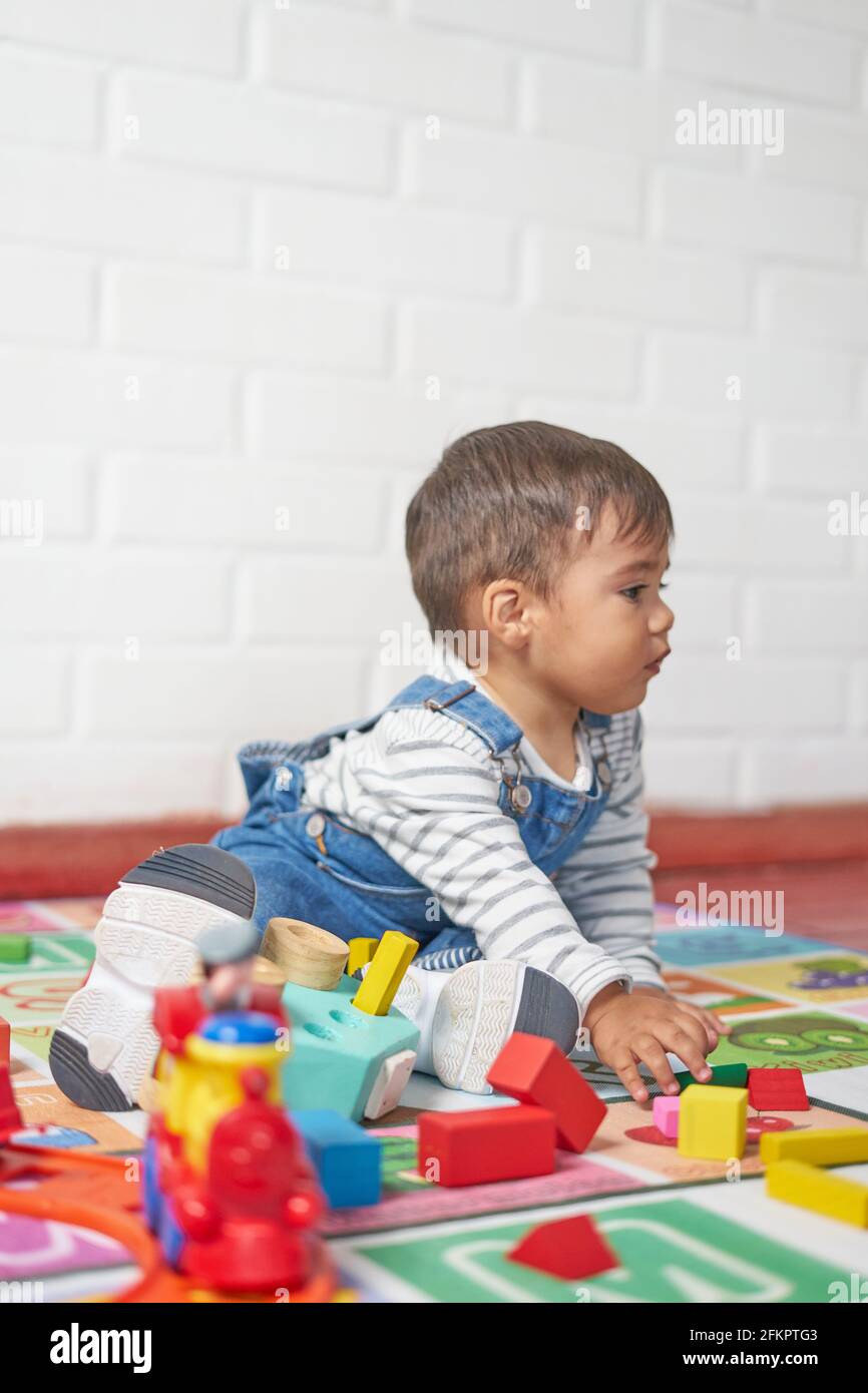 Baby playing in house Stock Photo - Alamy