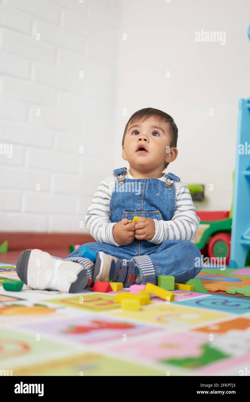 Baby playing in house Stock Photo - Alamy