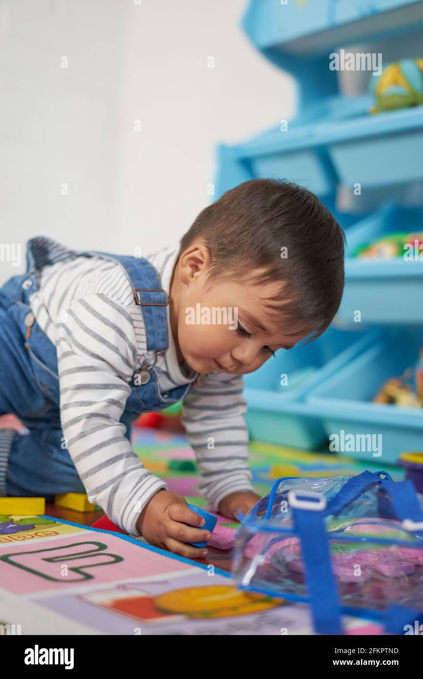 Baby playing in house Stock Photo - Alamy