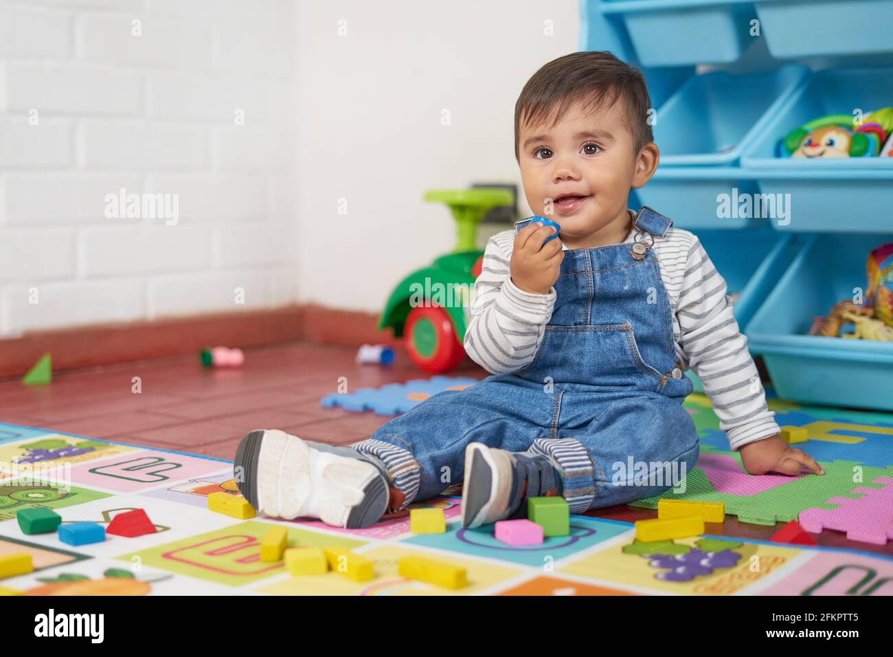 Baby playing in house Stock Photo - Alamy