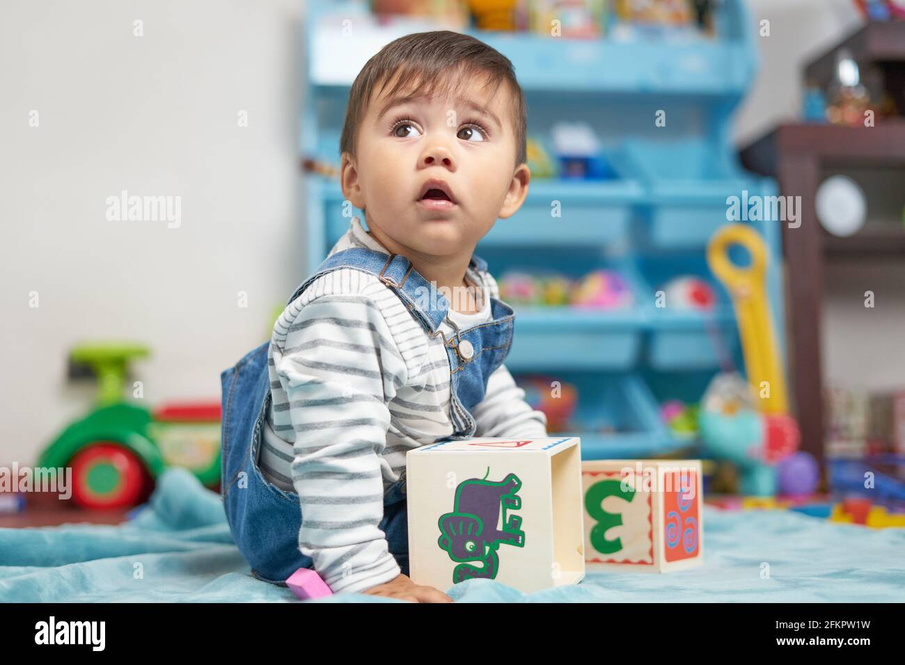 Baby playing in house Stock Photo - Alamy