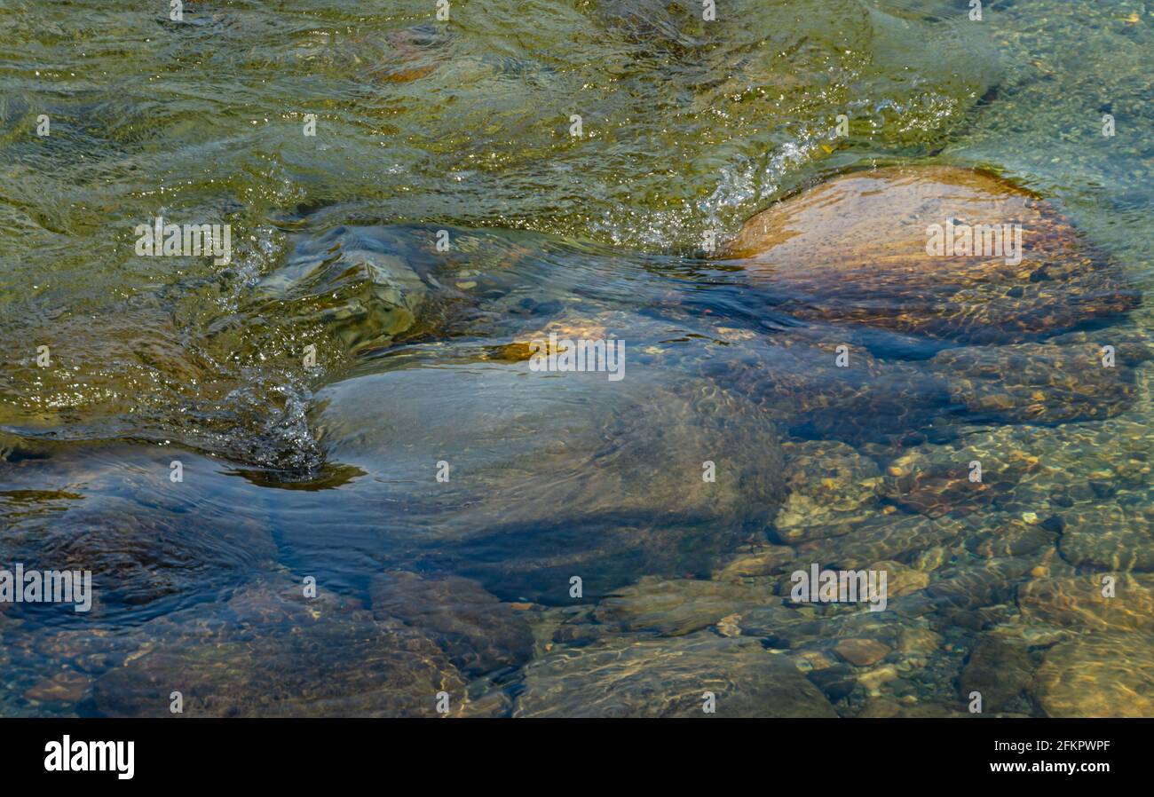 water swirling over rocks on river Stock Photo - Alamy